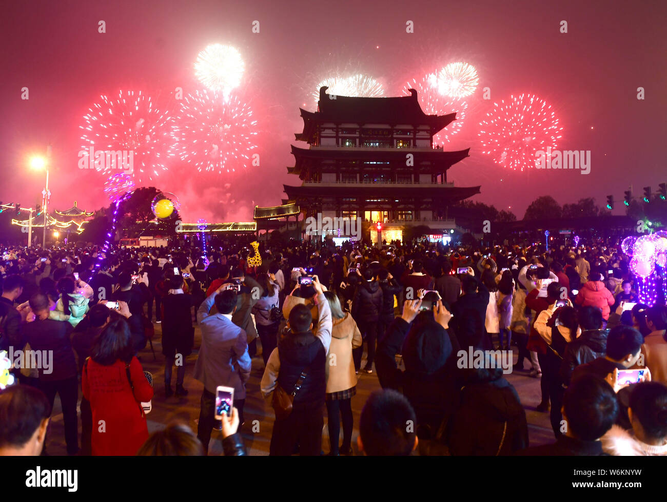 Visitors take photos of a firework show on New Year's Day at Orange ...