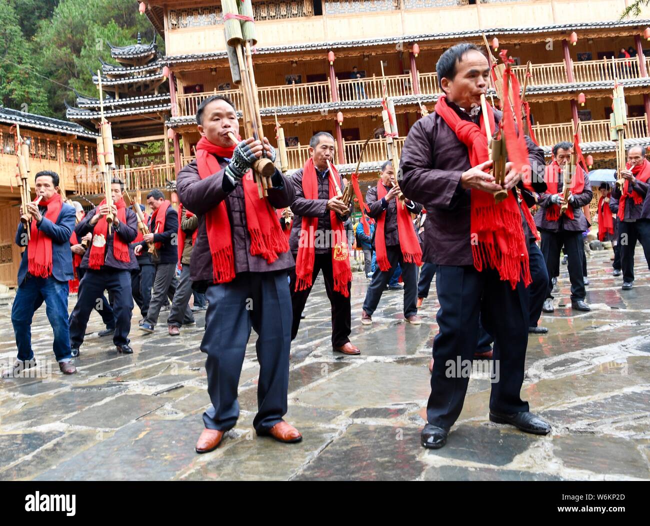 Chinese men of Dong ethnic group play the traditonal wind instrument ...