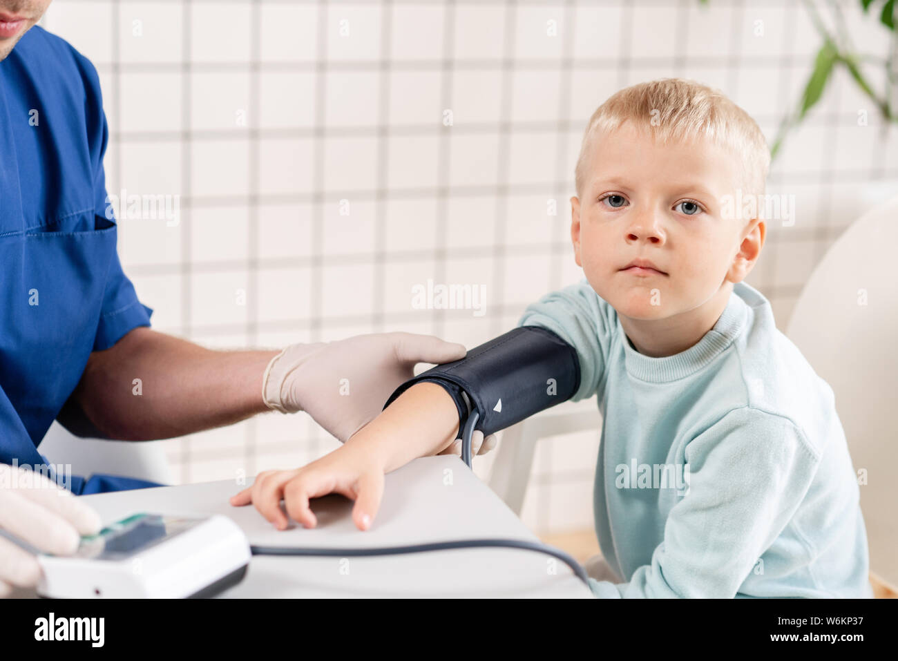 Doctor measuring blood pressure of a little boy. Diagnostic, healthcare ...
