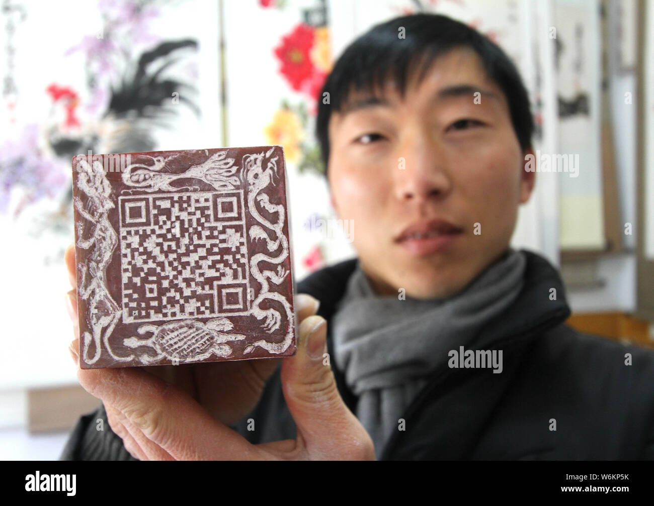 Chinese young man Cao Yewei shows his QR code seal in Handan city ...