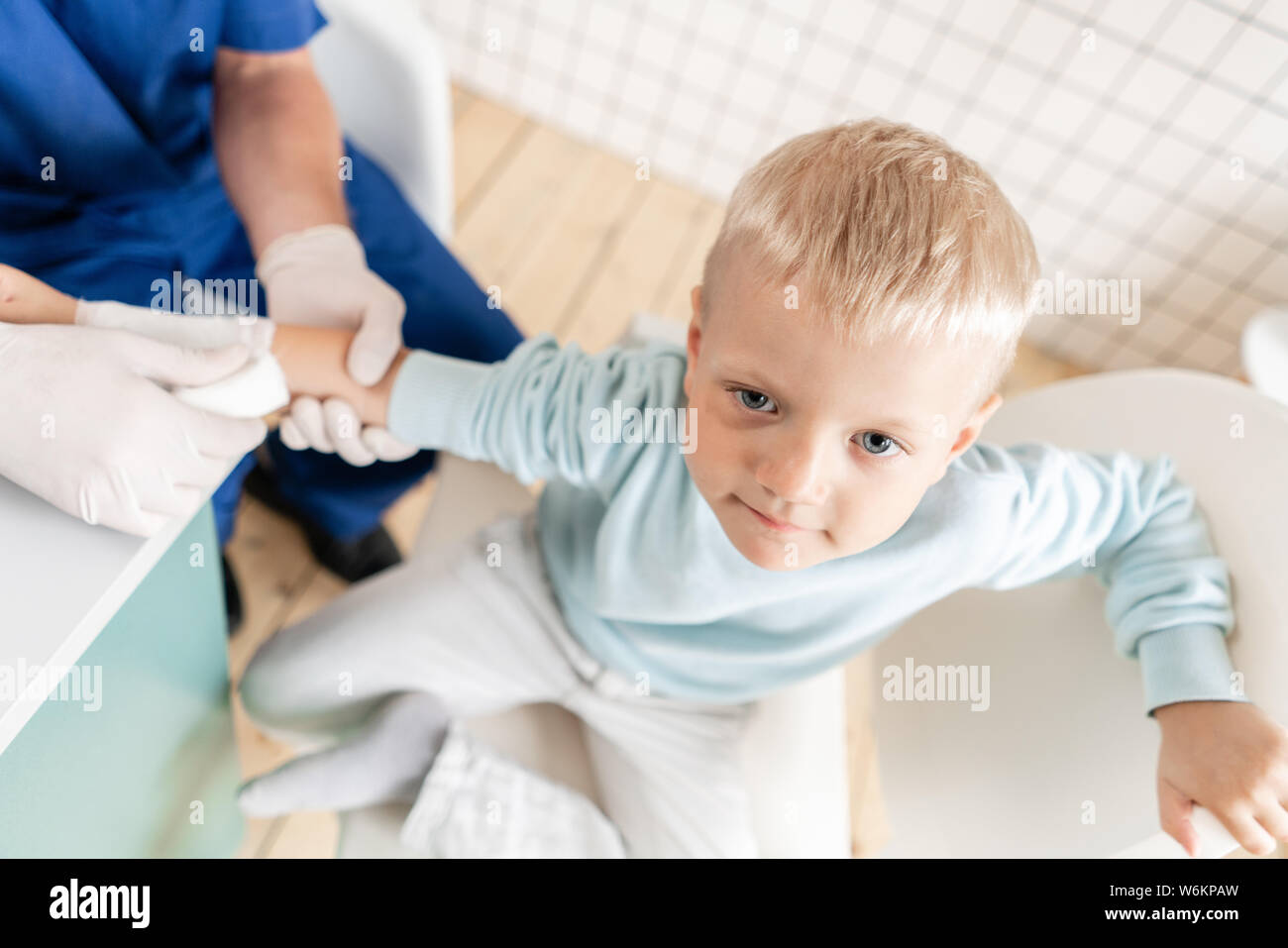 Doctor bandaged a boy hand with trauma in his arm. Elastic bandaged ...