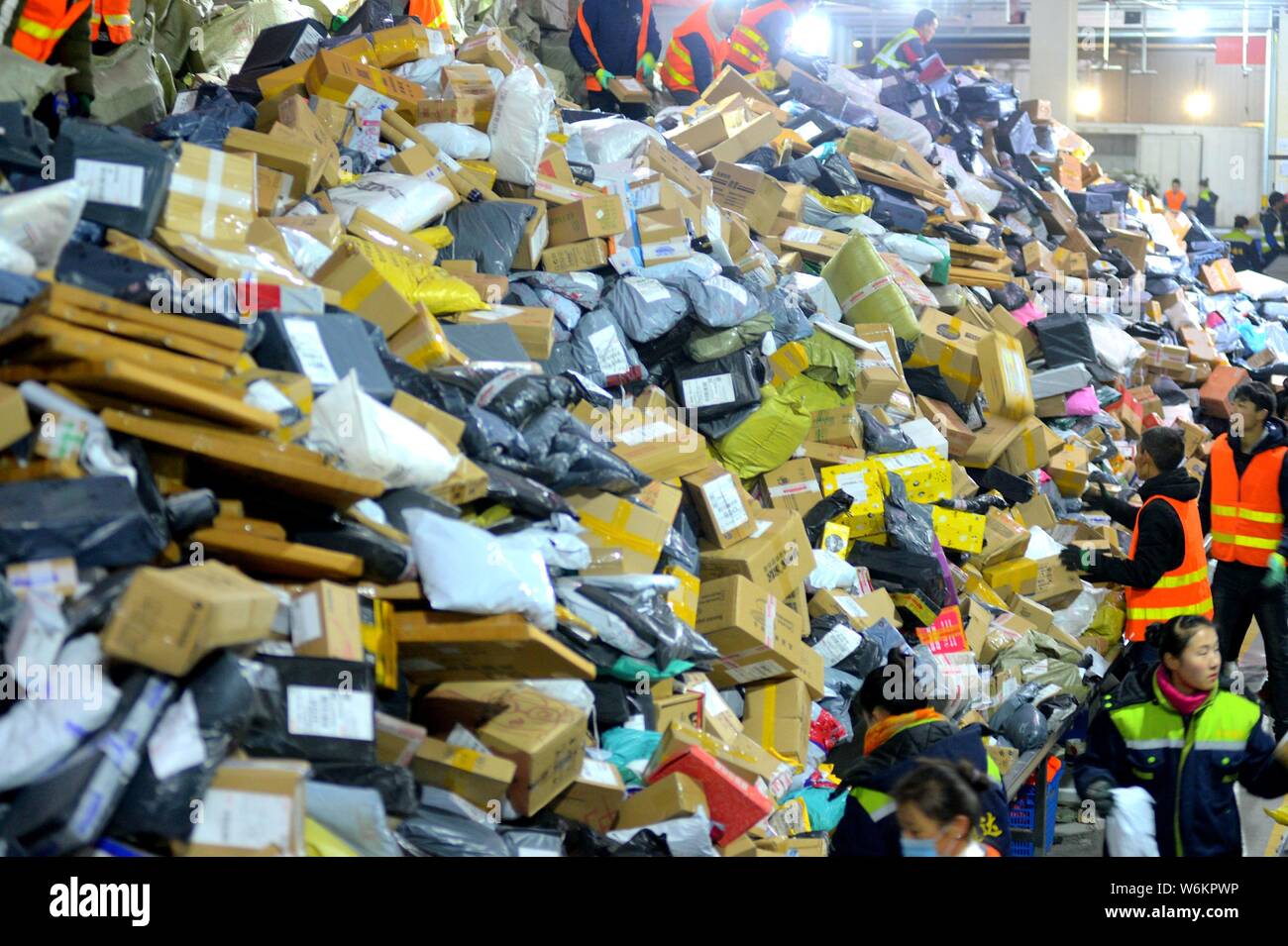 --FILE--Chinese workers sort out piles of parcels, most of which are ...
