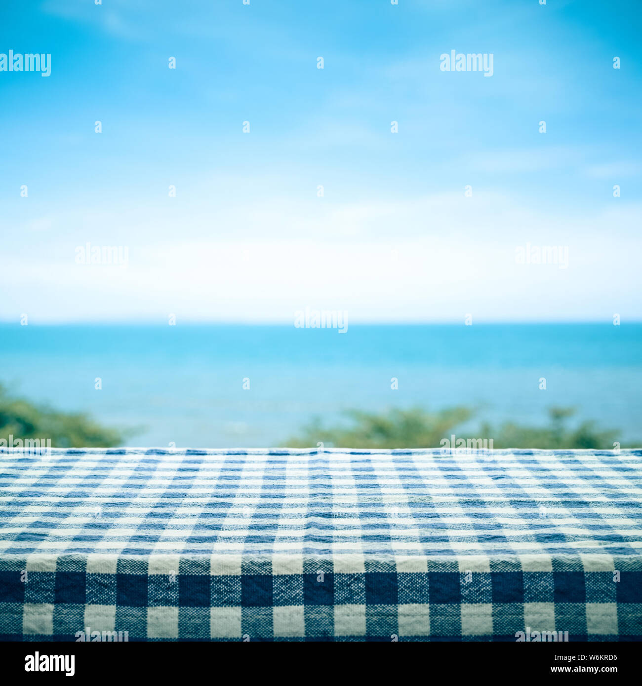 Checkered tablecloth texture with sea view background.For montage ...