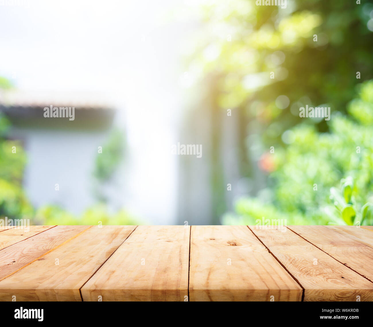 Empty wood table top on blur abstract green from garden and home area ...