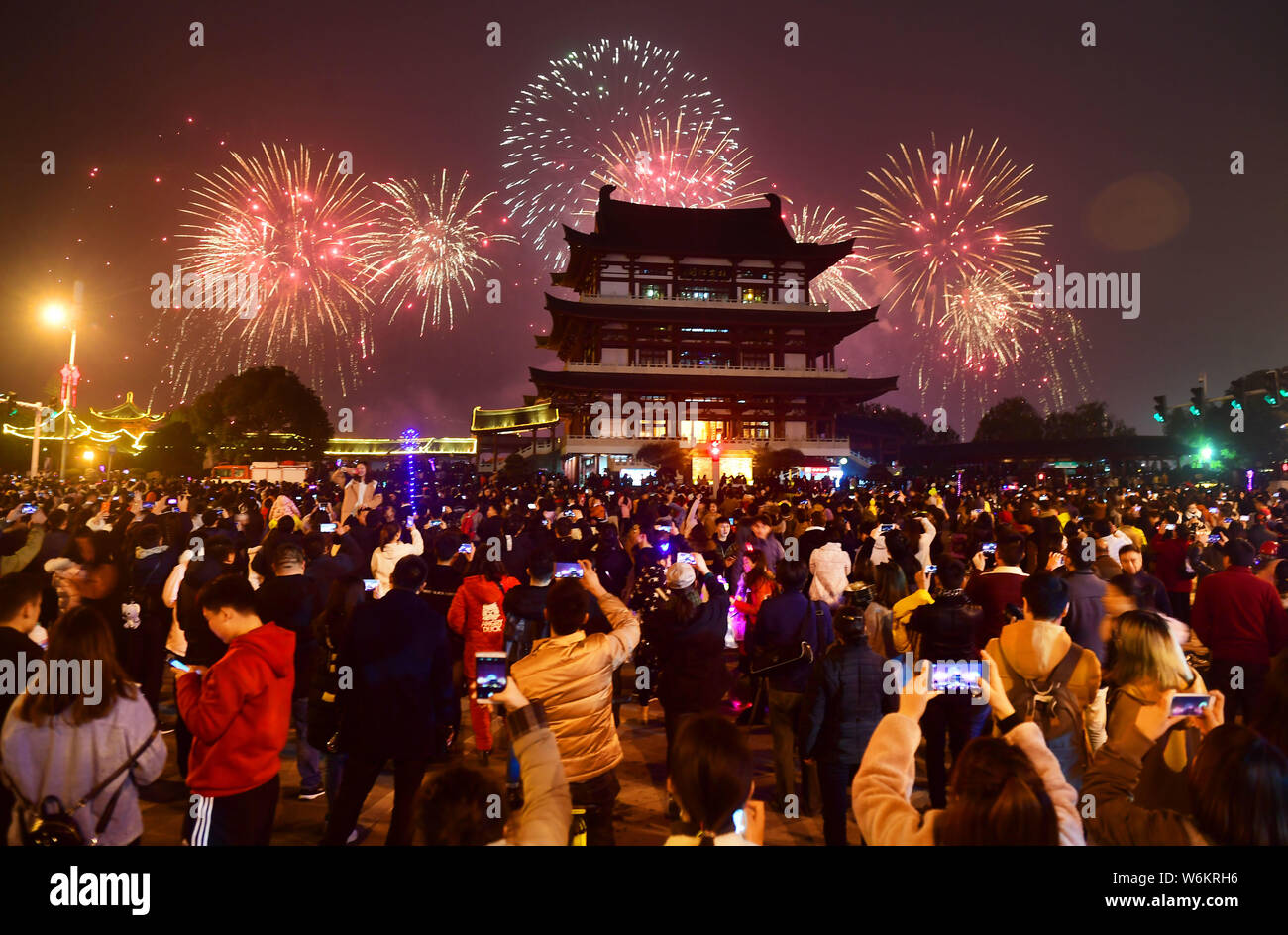 Visitors take photos of a firework show on New Year's Day at Orange ...