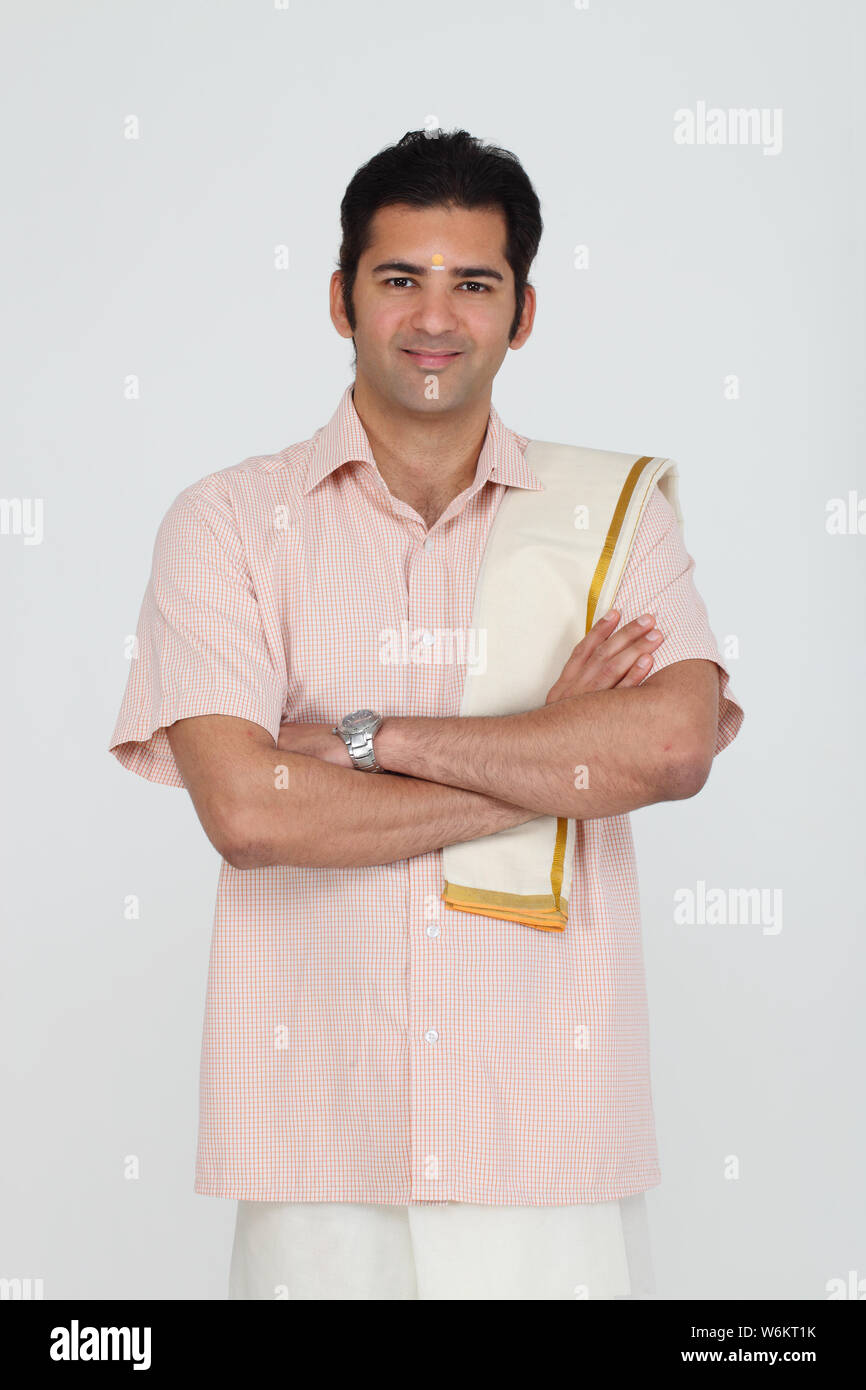 South Indian man standing with his arms crossed Stock Photo - Alamy