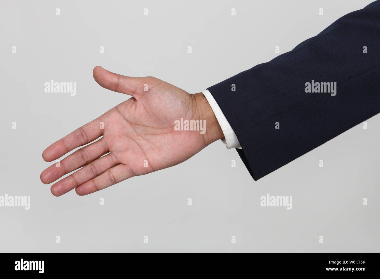 Businessman offering hand for handshake Stock Photo - Alamy