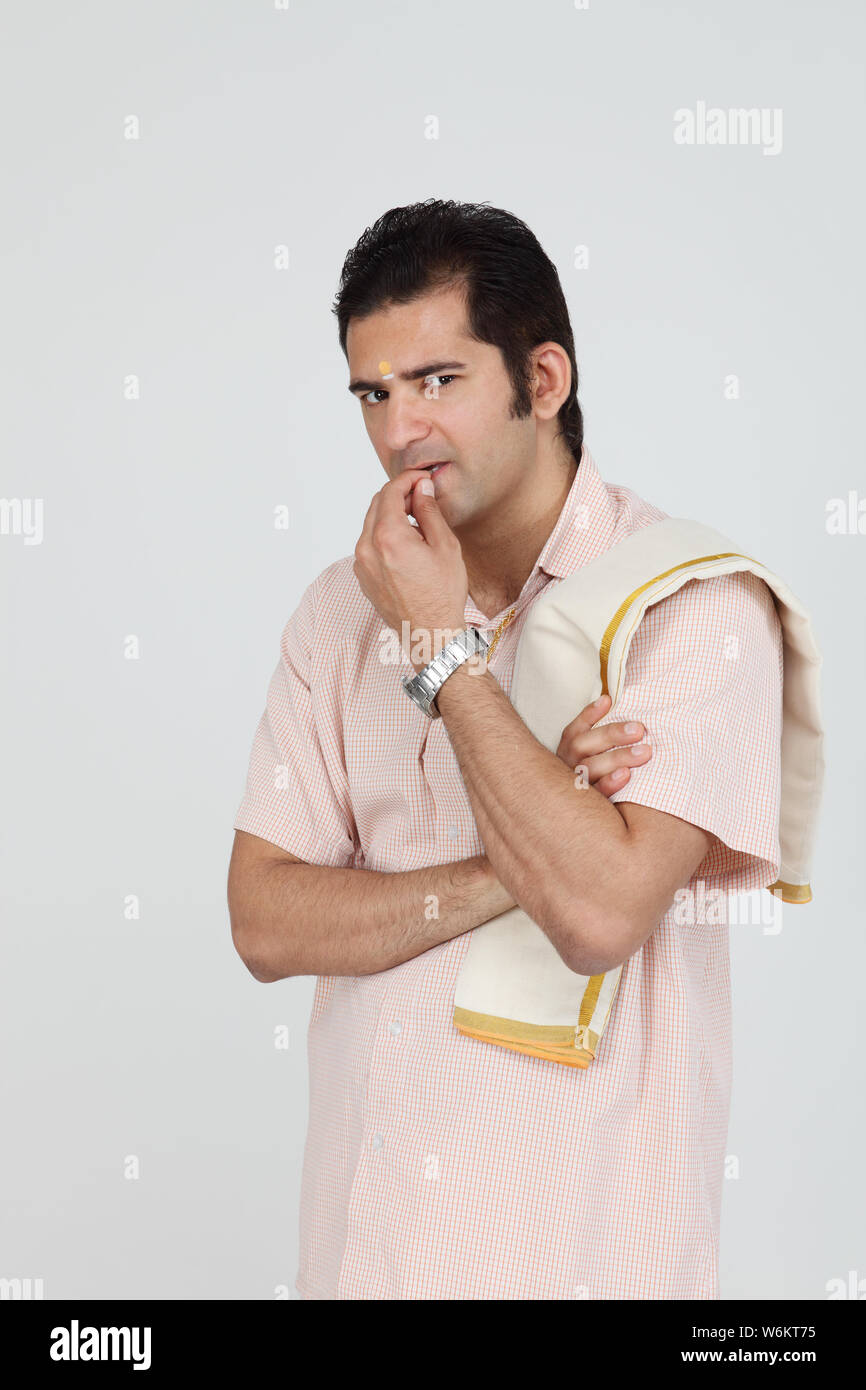Portrait of a south Indian man biting nails Stock Photo - Alamy