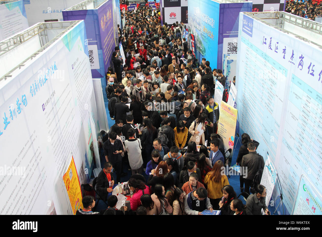 --FILE--Graduates look for employment at a job fair in the campus of ...