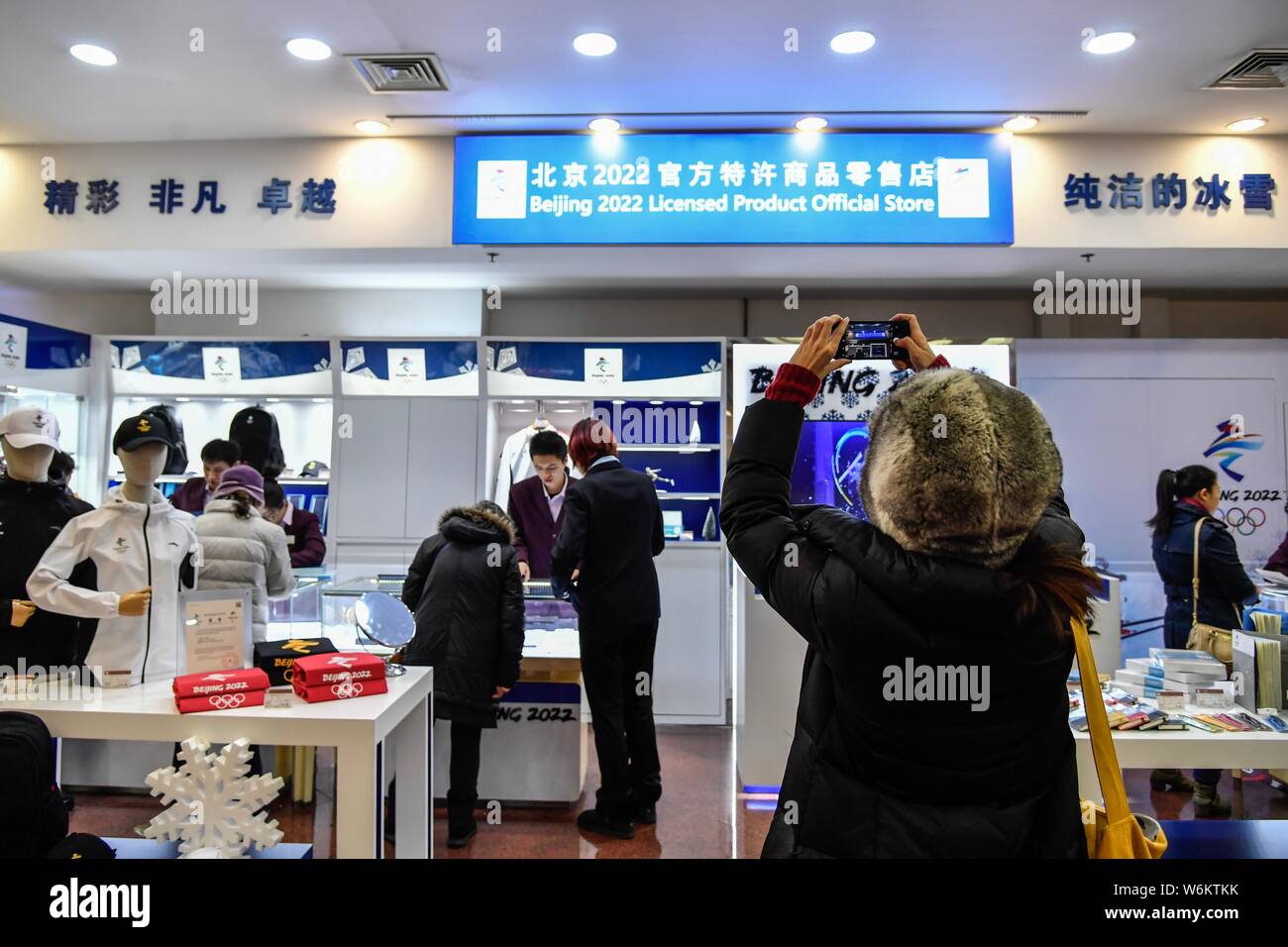A Chinese customer takes photos at one of the first seven licensed ...