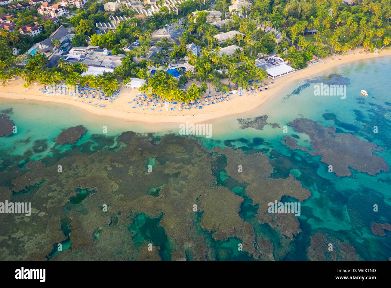 Drone shot of tropical beach with white boat anchored.Samana peninsula ...
