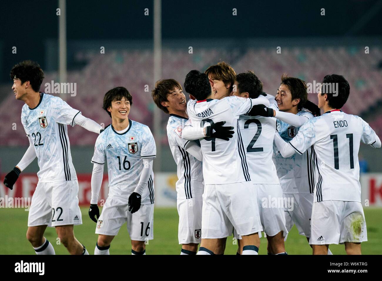 Players of Japan celebrate after scoring against Thailand in their Group B match during the 2018 ...