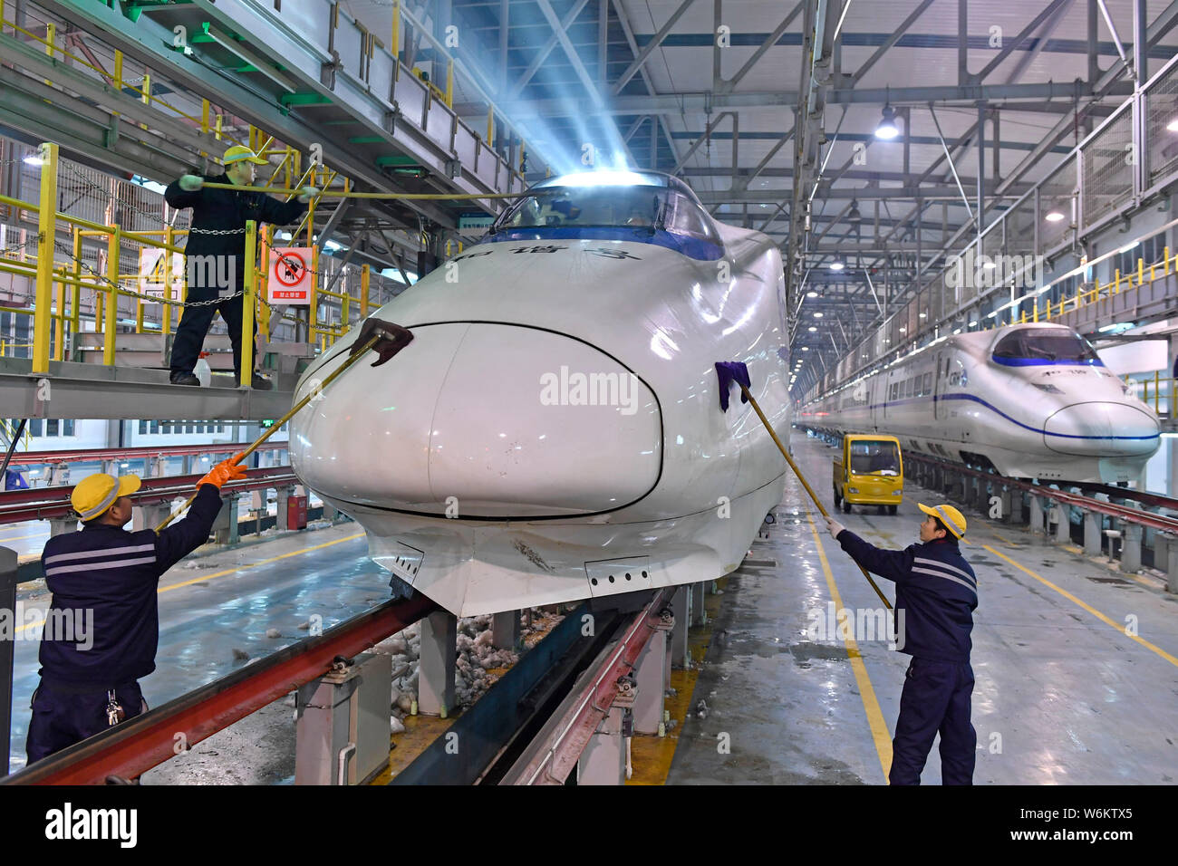Chinese workers clean a CRH (China Railway High-speed) bullet train for ...