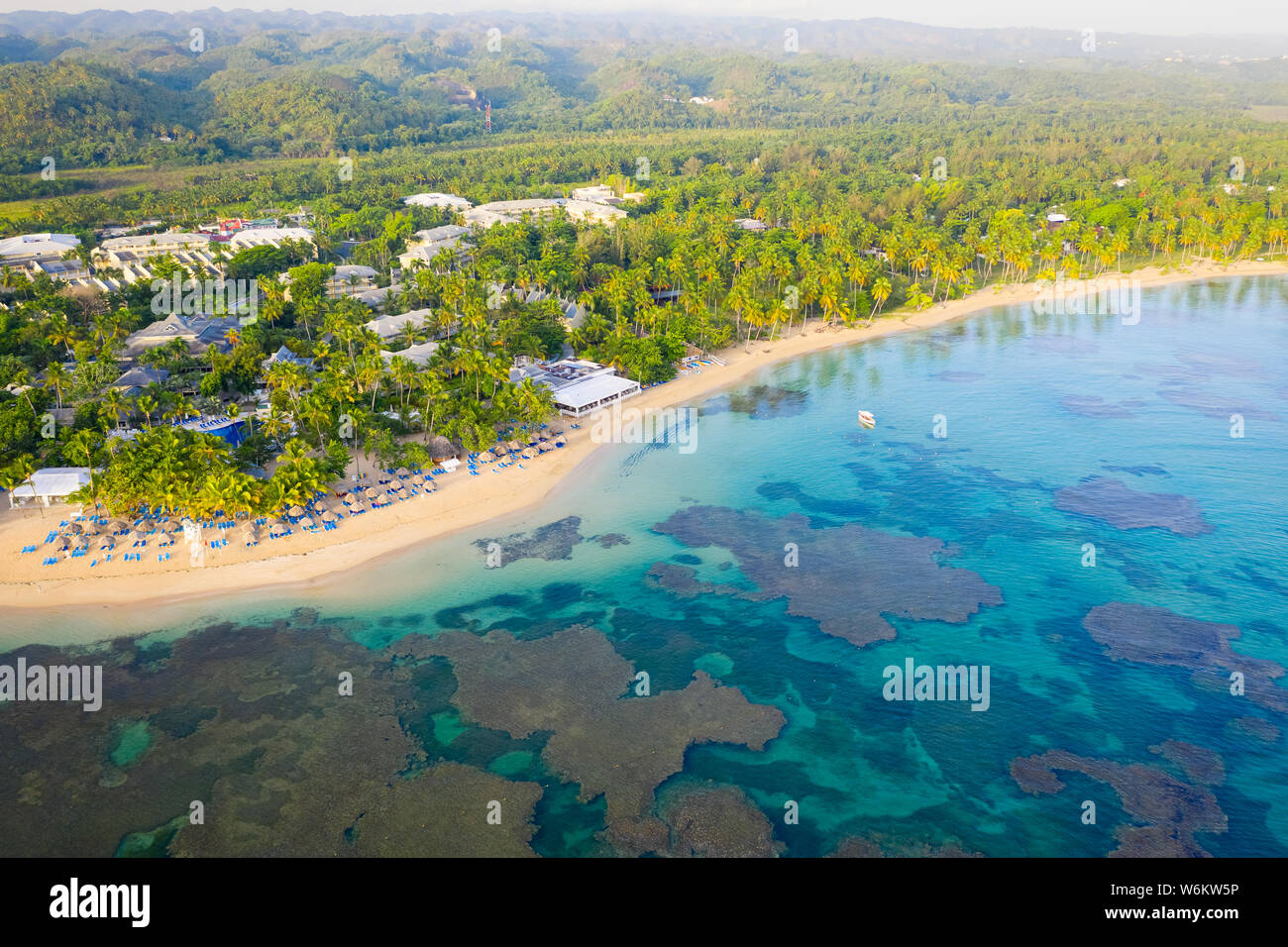 Drone shot of tropical beach with white boat anchored.Samana peninsula ...