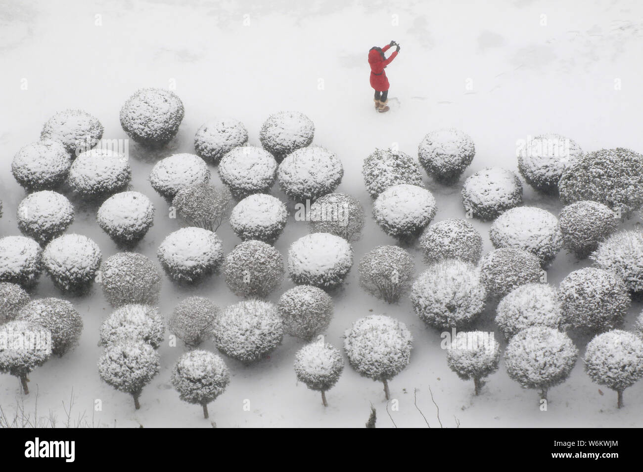 A local woman takes a selfie on a snow-covered road in Yantai city ...