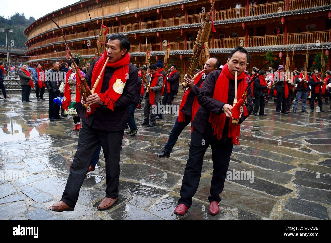 Chinese men of Dong ethnic group play the traditonal wind instrument ...