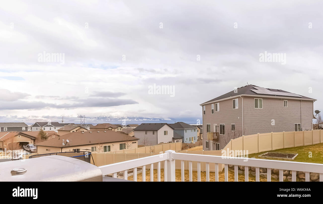Panorama frame Brown wooden deck with white railing overlooking yard ...