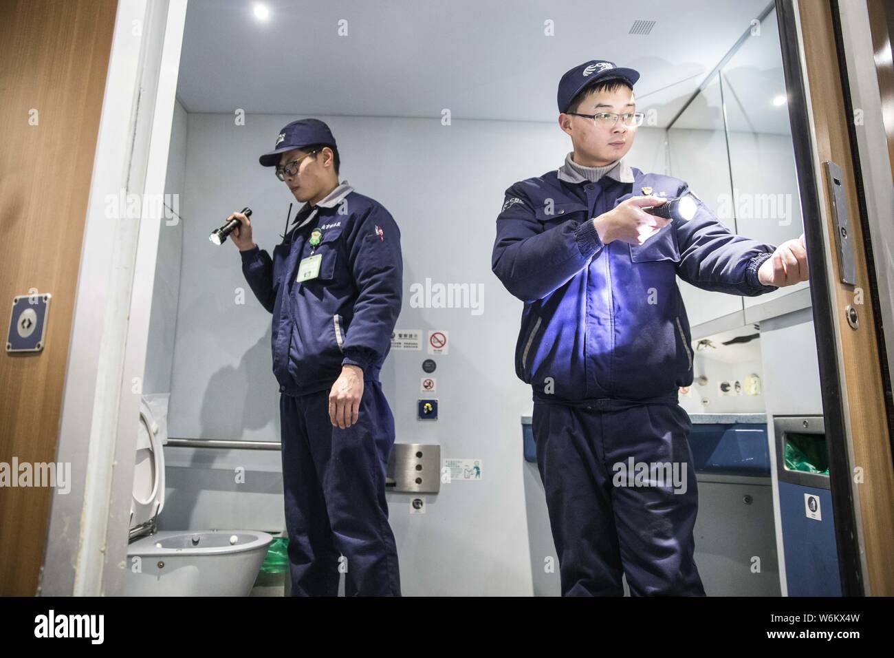 Chinese workers check a CRH (China Railway High-speed) bullet train for ...