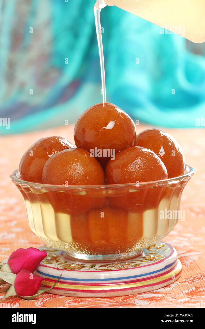 Sugar syrup being poured on Gulab jamun Stock Photo - Alamy