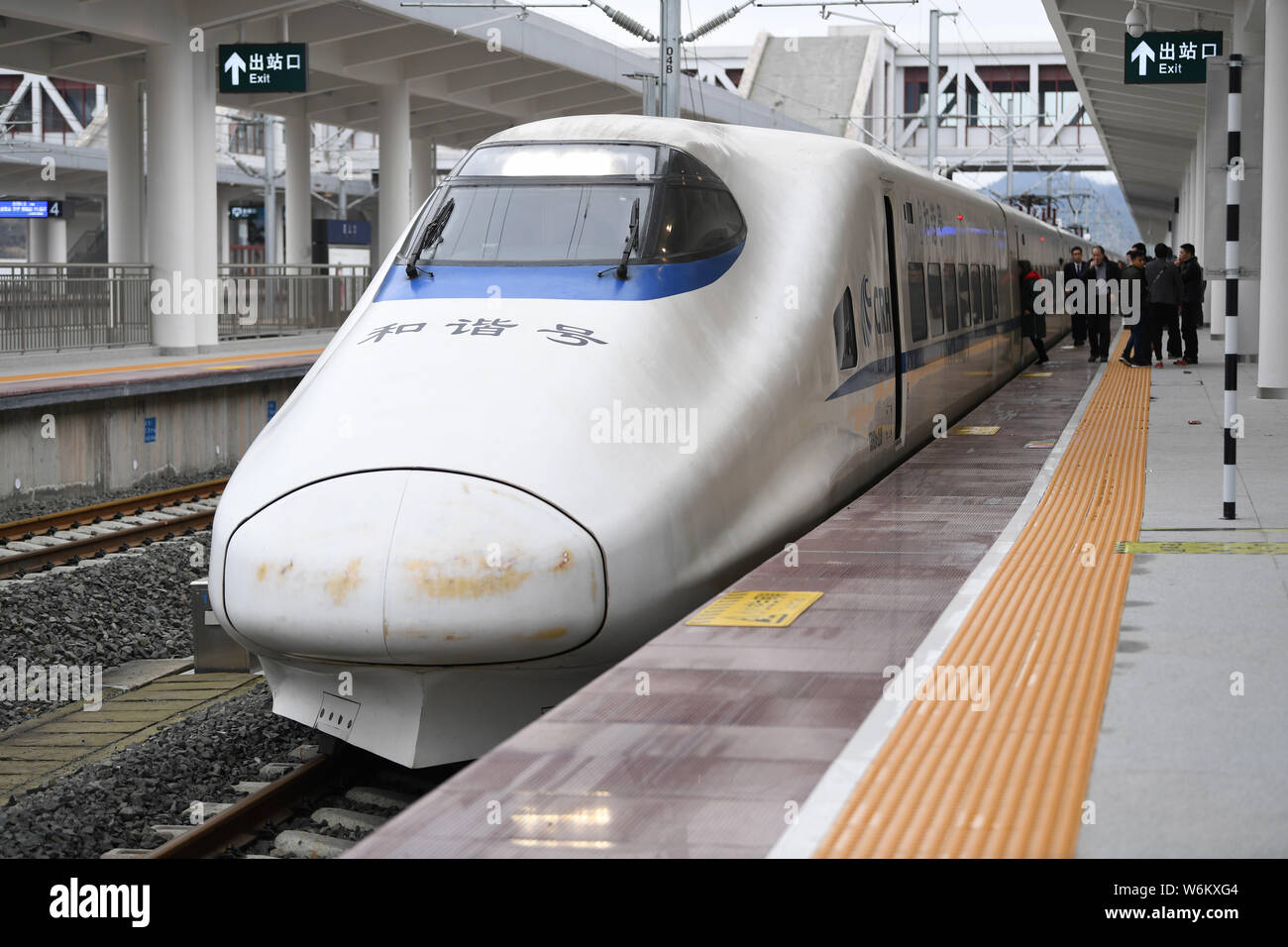 Passengers enter a CRH (China Railway High-speed) bullet train at the ...