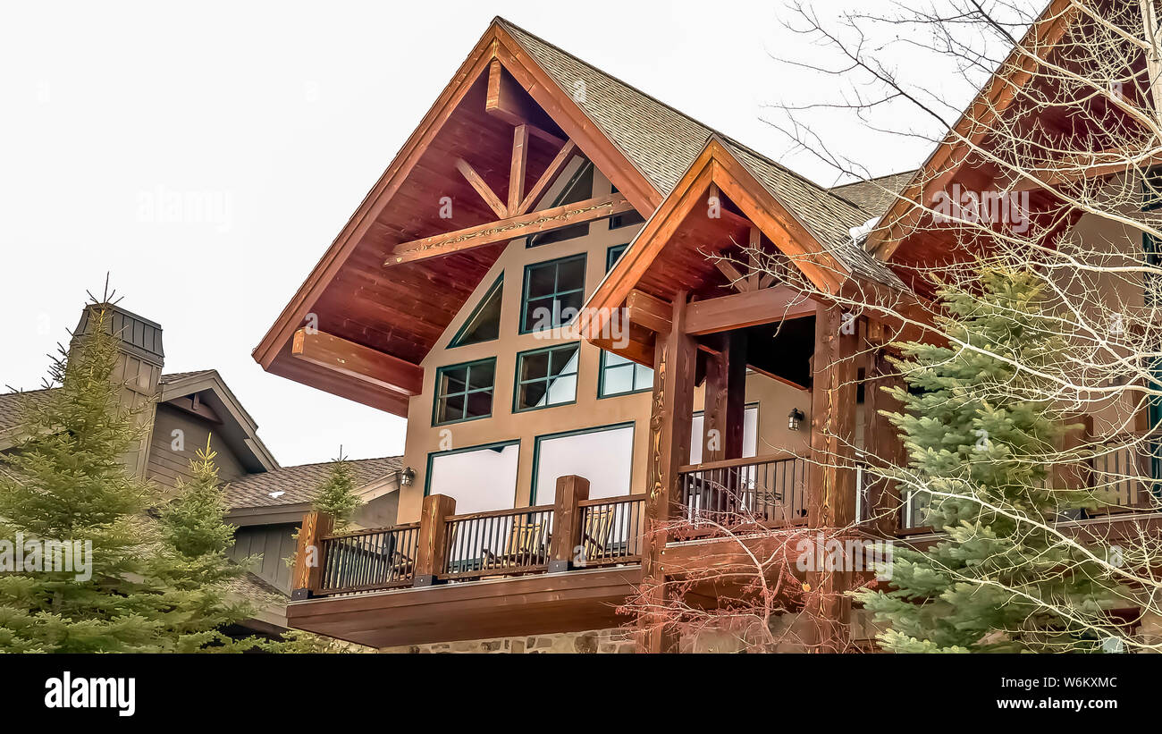 Panorama Beautiful house exterior surrounded by snow y ground and ...