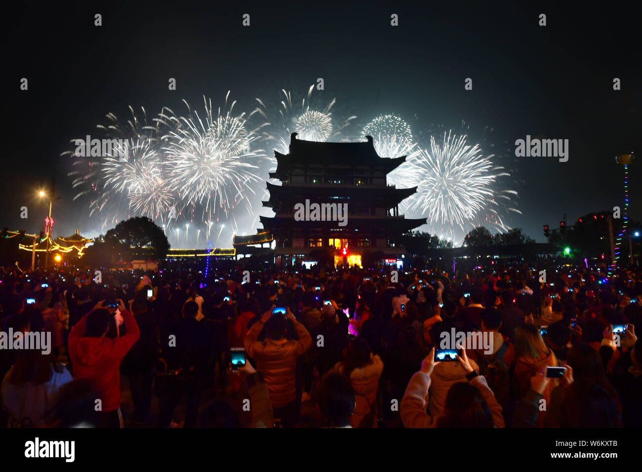 Visitors take photos of a firework show on New Year's Day at Orange ...