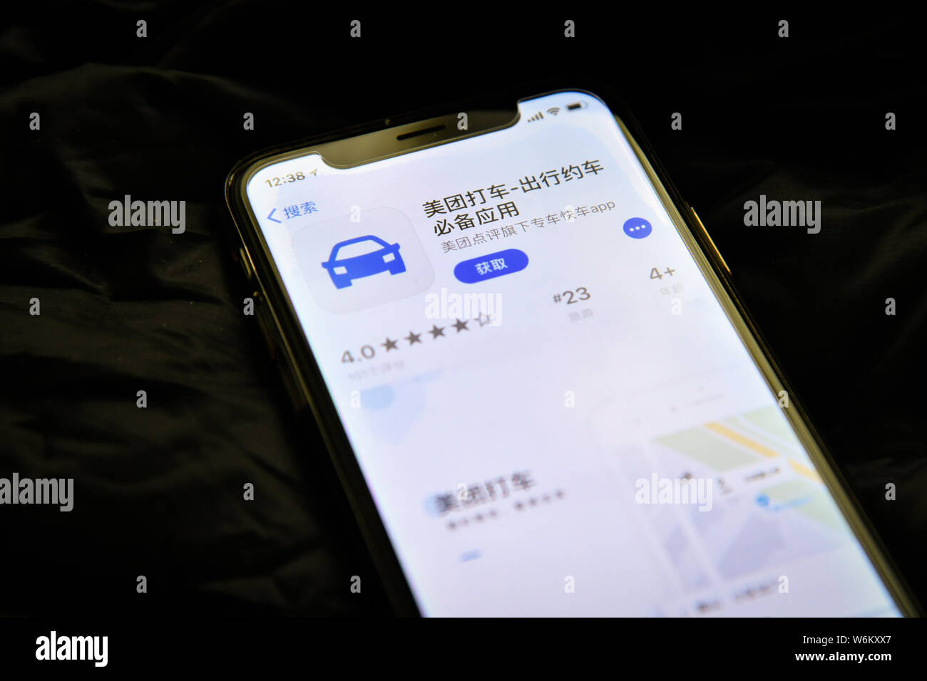 A mobile phone user shows the icon of Meituan Dache, the car-hailing ...