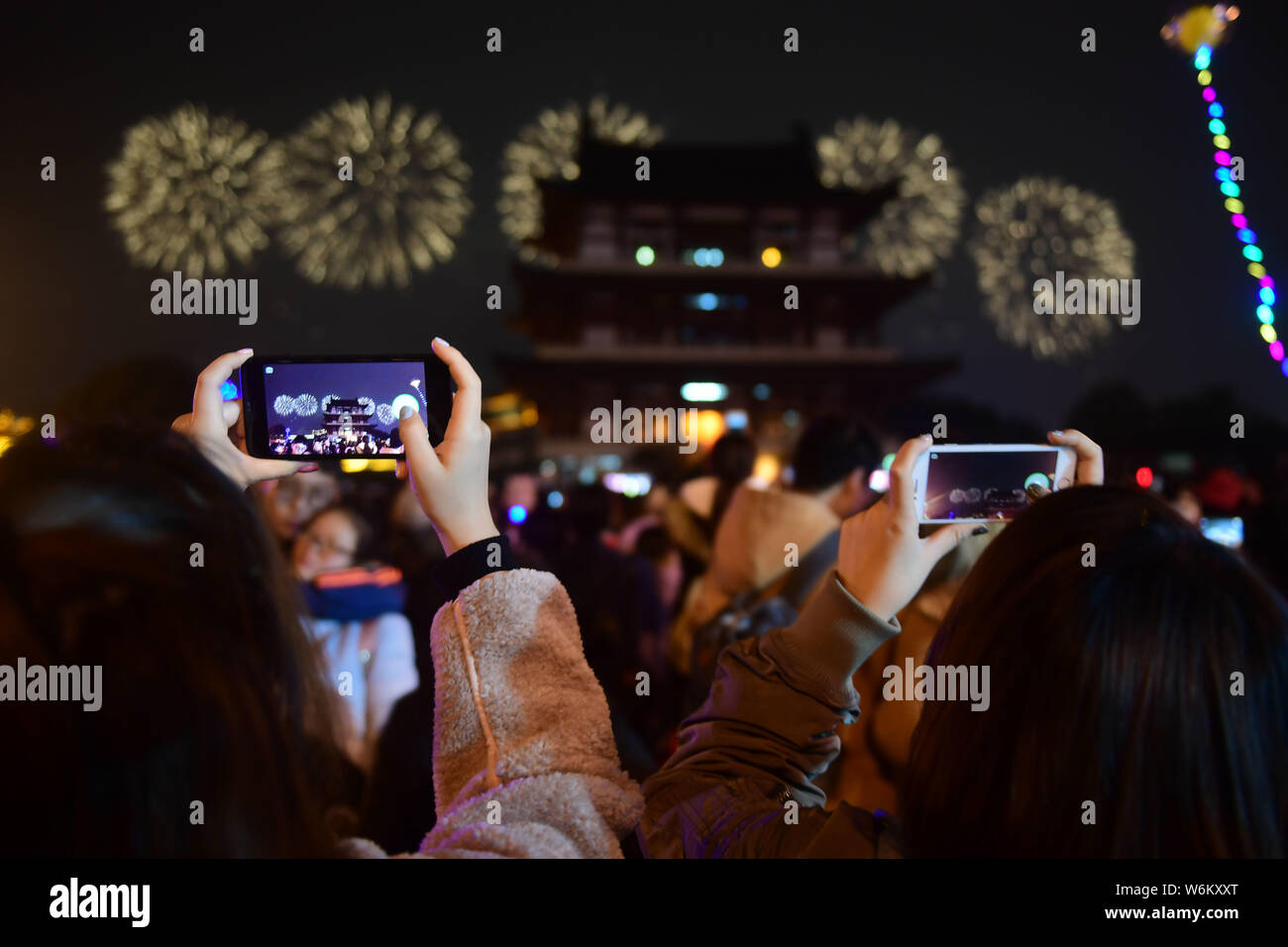 Visitors take photos of a firework show on New Year's Day at Orange ...