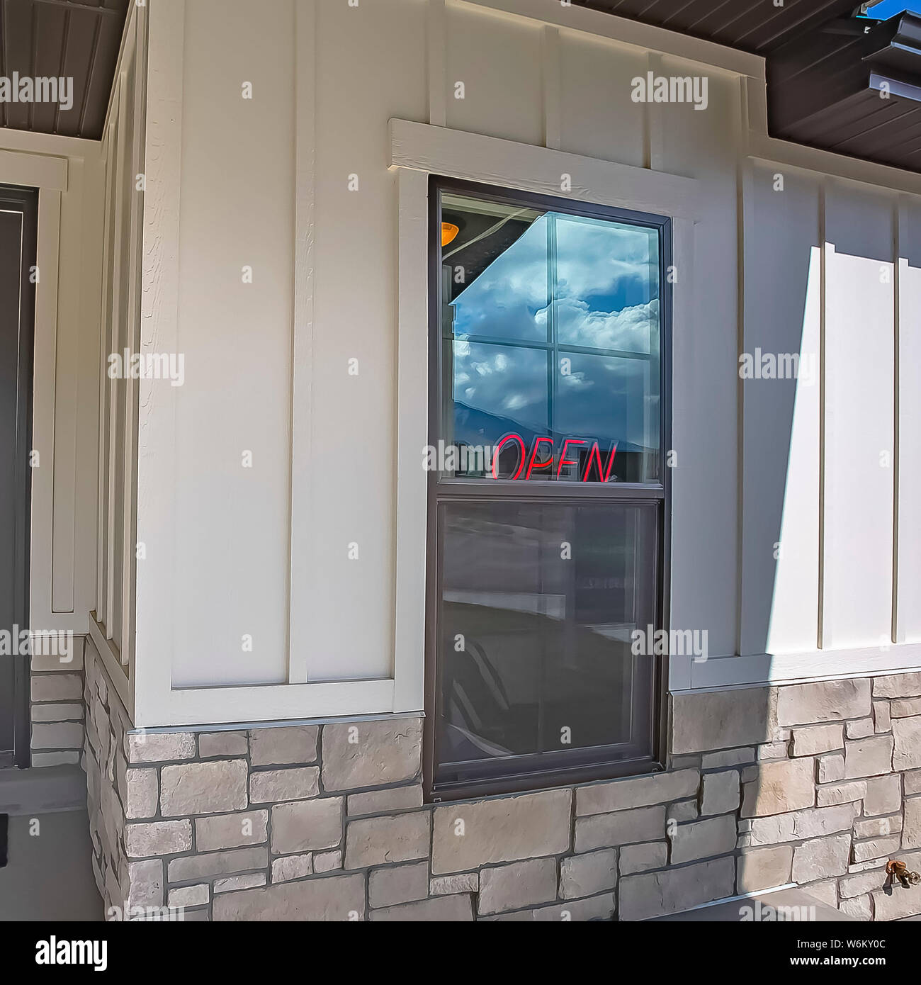 Square frame Building facade with glass paned door and a combination of ...
