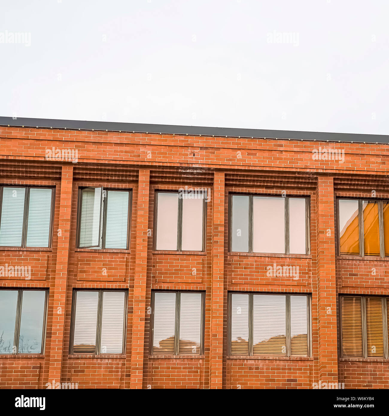 Square frame Exterior of red brick building with flat rooftop and shiny ...