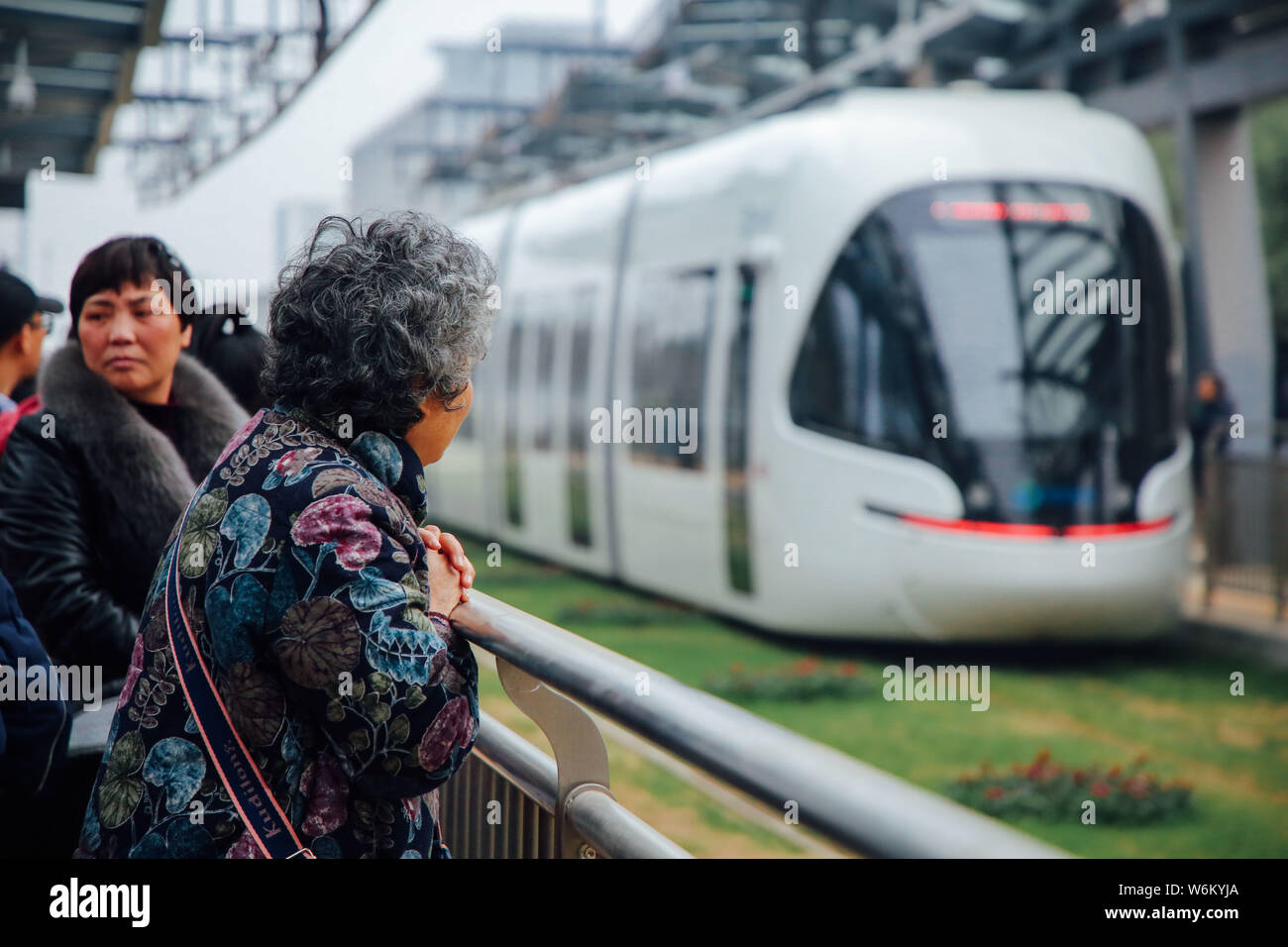 Passengers wait for an "Optics Valley Quantum" tram during the trial ...
