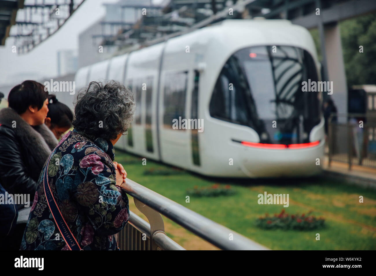 Passengers wait for an "Optics Valley Quantum" tram during the trial ...