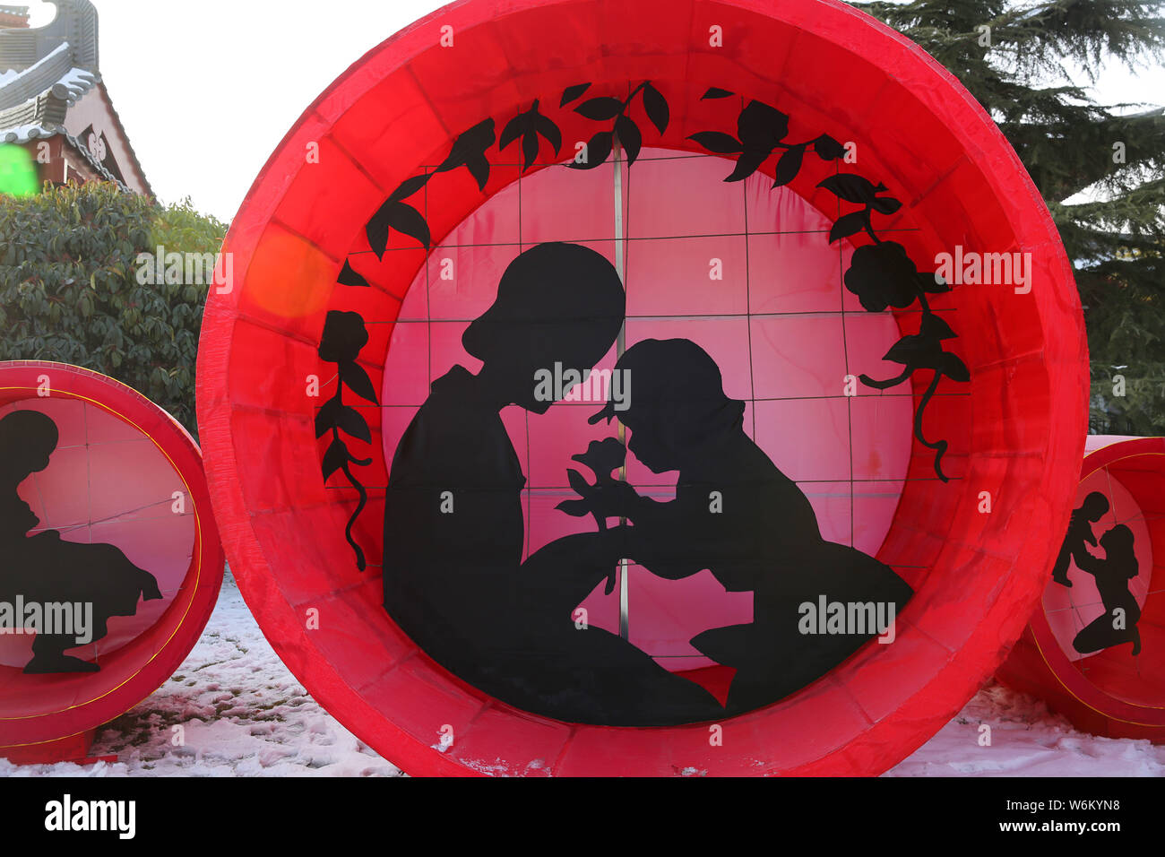 A mother and kid-themed shadowy figure lantern is on display for the ...