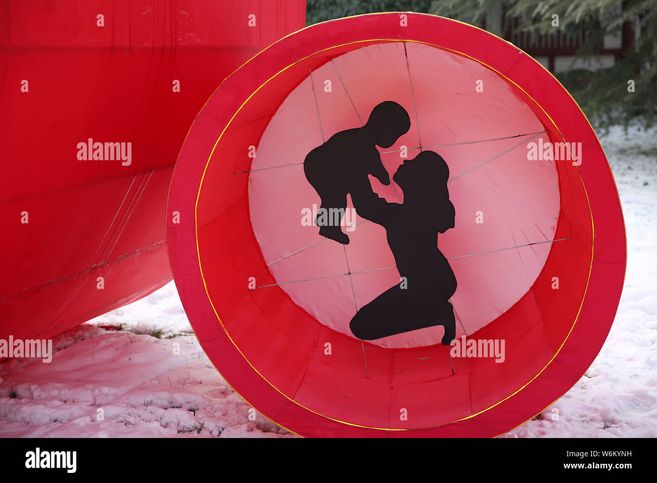 A mother and kid-themed shadowy figure lantern is on display for the ...