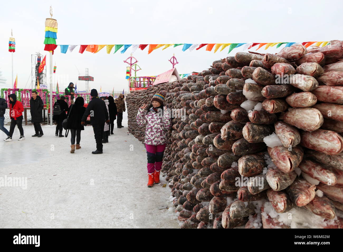 Tourists look at a 10-meter-long "fish wall" composed of more than ...
