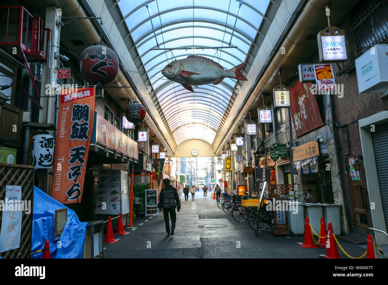 Customers walk through the Kuromon Ichiba market in Osaka, Japan, 19 ...