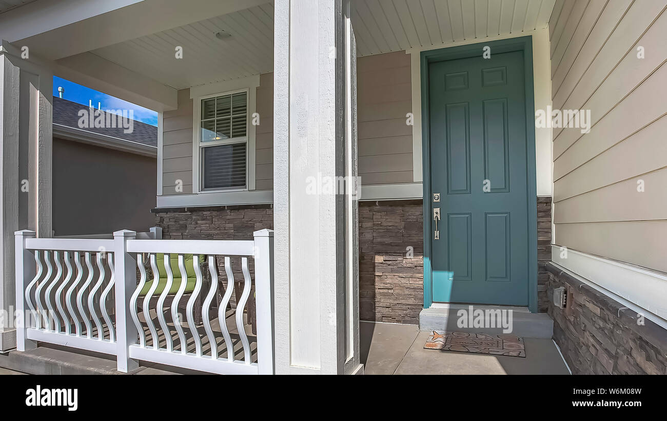 Panorama frame Green front door and porch with furniture at the facade ...