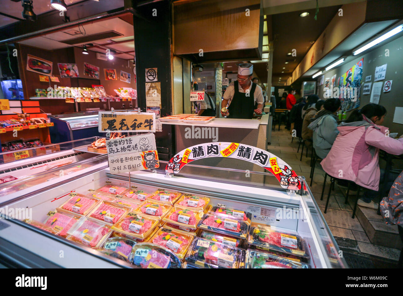 View of a meat food shop at the Kuromon Ichiba market in Osaka, Japan ...