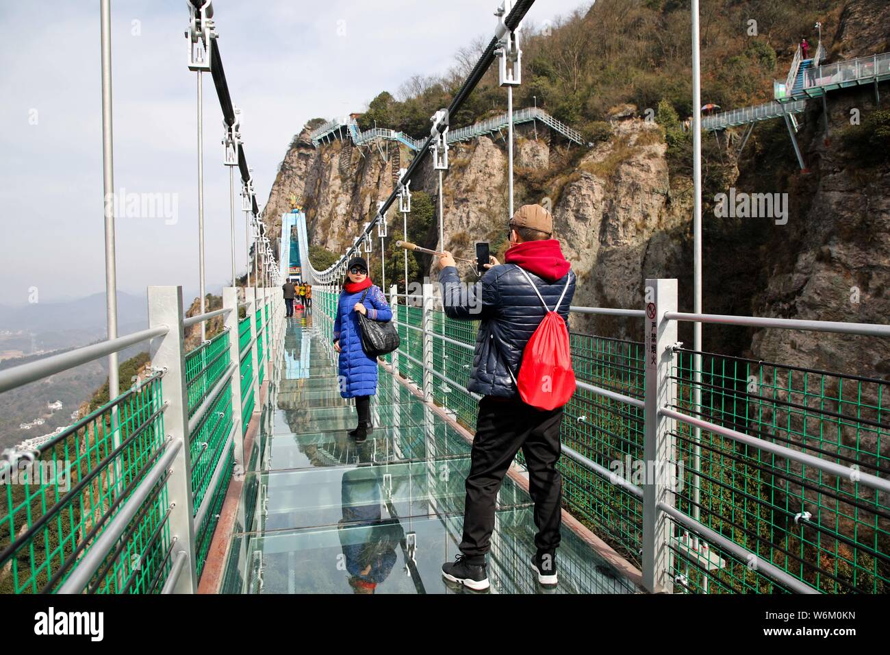 Tourists pose for photos on the glass bridge called "Flying Dragon in ...