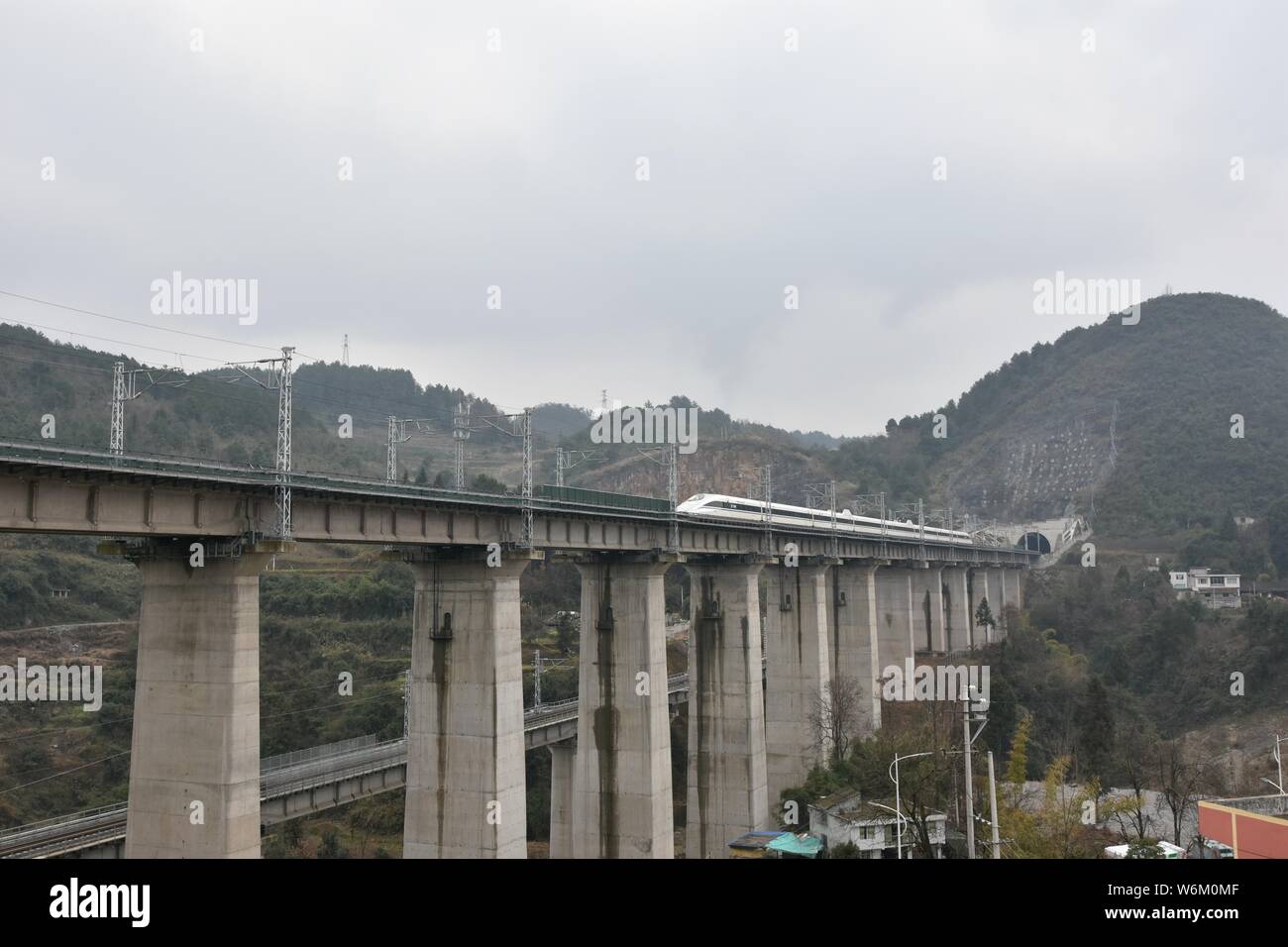 A CRH (China Railway High-speed) bullet train runs on the Chongqing ...