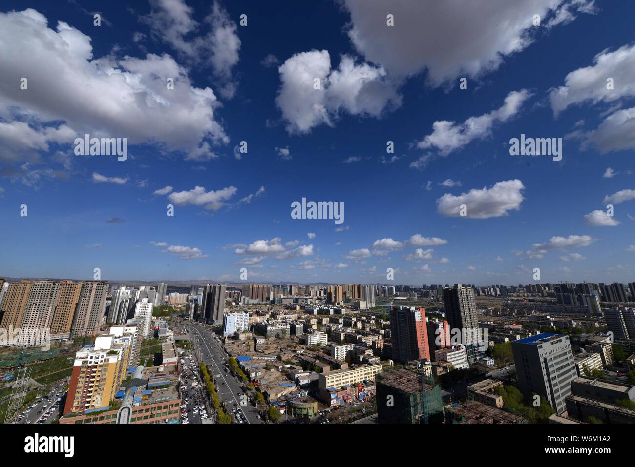 Cityscape of Korla city on a sunny day with clouds in the blue sky in ...
