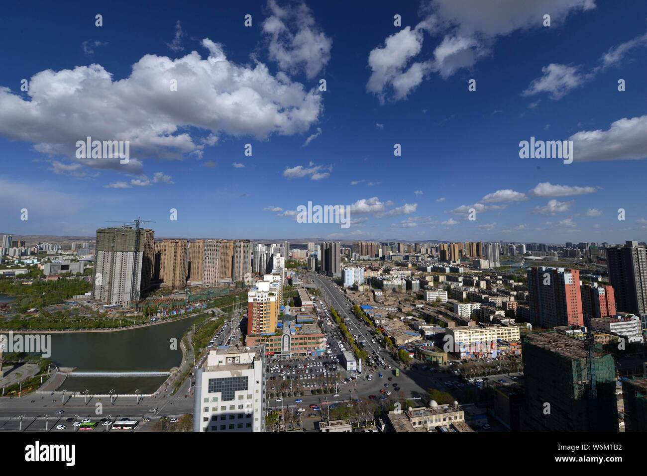 Cityscape of Korla city on a sunny day with clouds in the blue sky in ...
