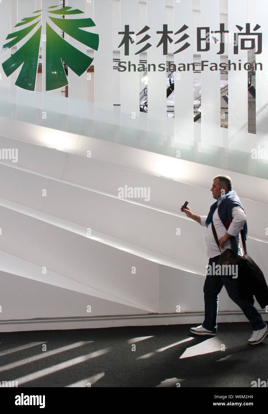 --FILE--A visitor walks past the stand of Ningbo Shanshan Co. during an ...