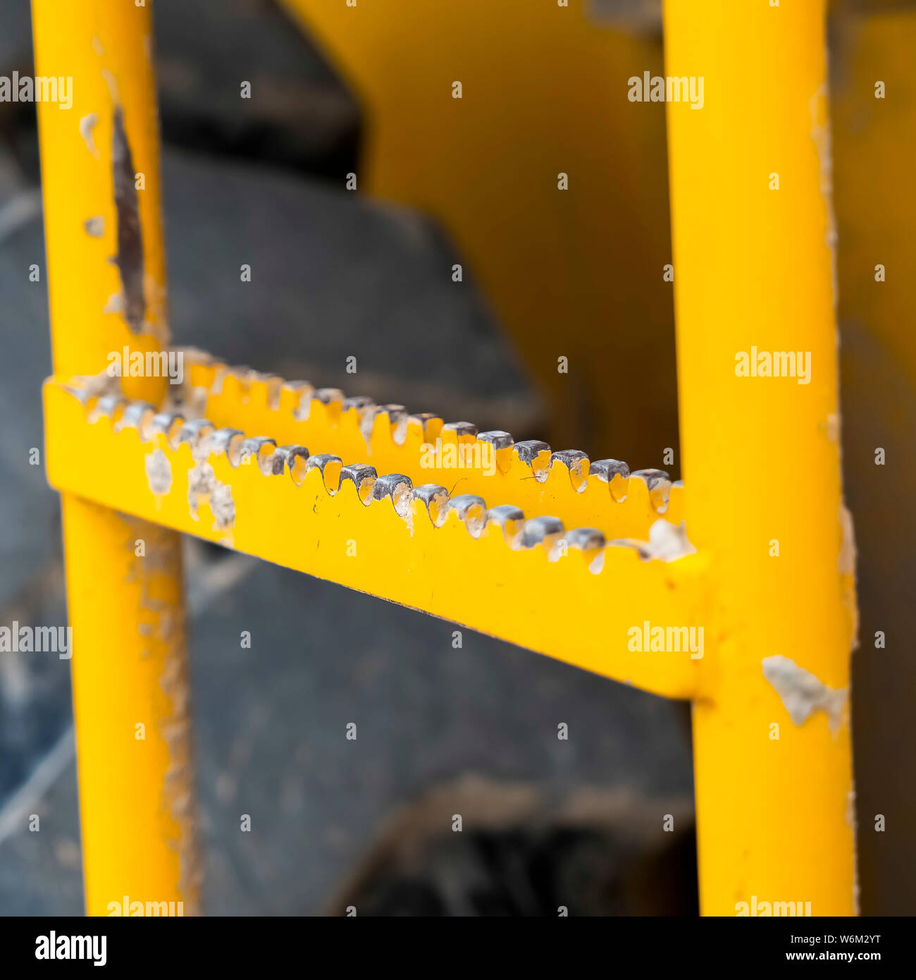 Close up of the ladder with peeling yellow paint of a construction ...