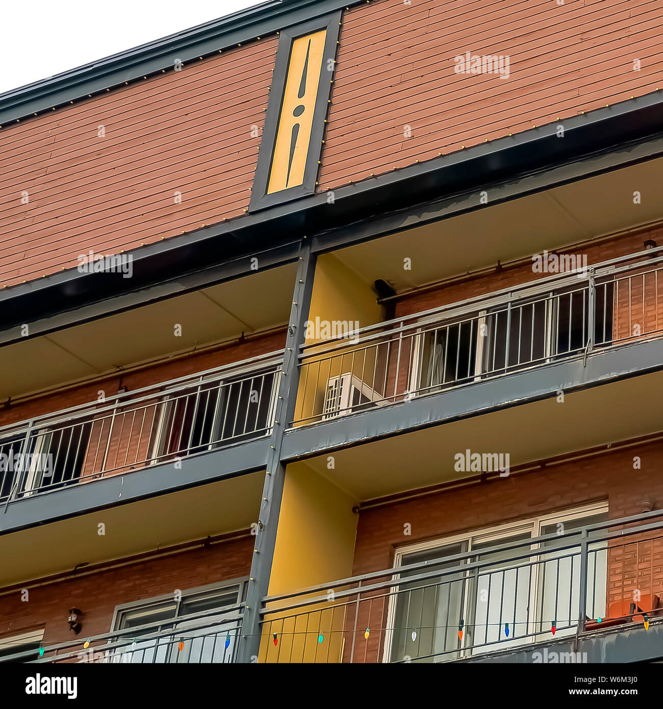 Square Residential building with flat roof balconies and red brick ...
