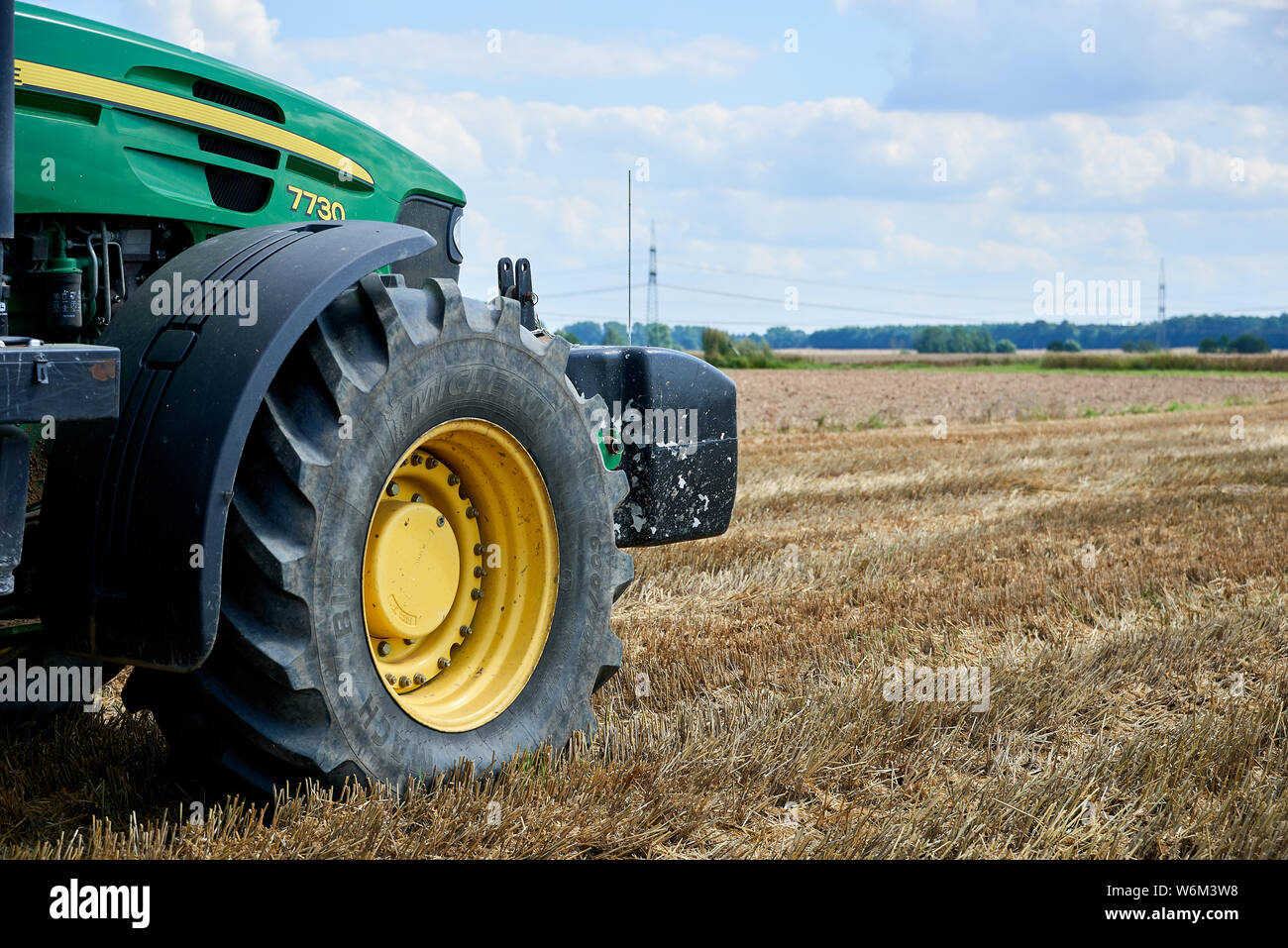 two harvester unloading corn on tractor Stock Photo - Alamy