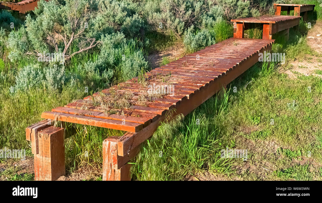 Panorama Close up of elevated wooden bike tracks amid grasses and ...
