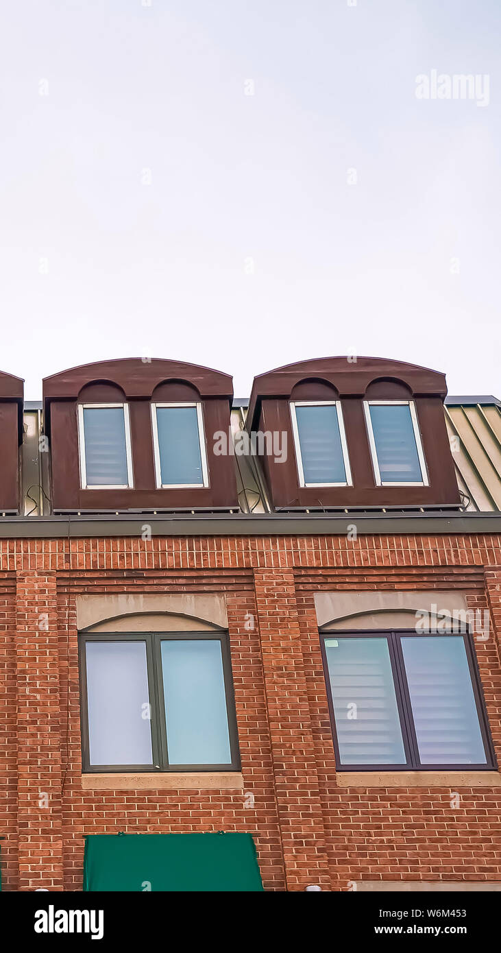 Vertical frame Exterior view of a building with red brick wall and ...
