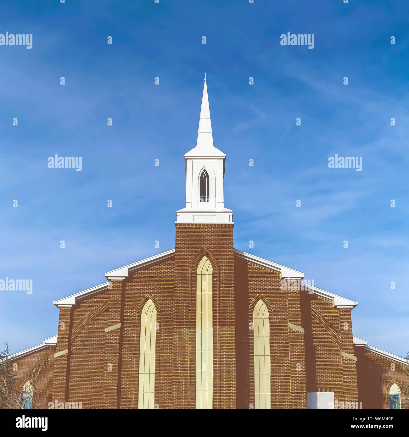 Square frame Exterior view of a magnificent church with cloudy blue sky ...