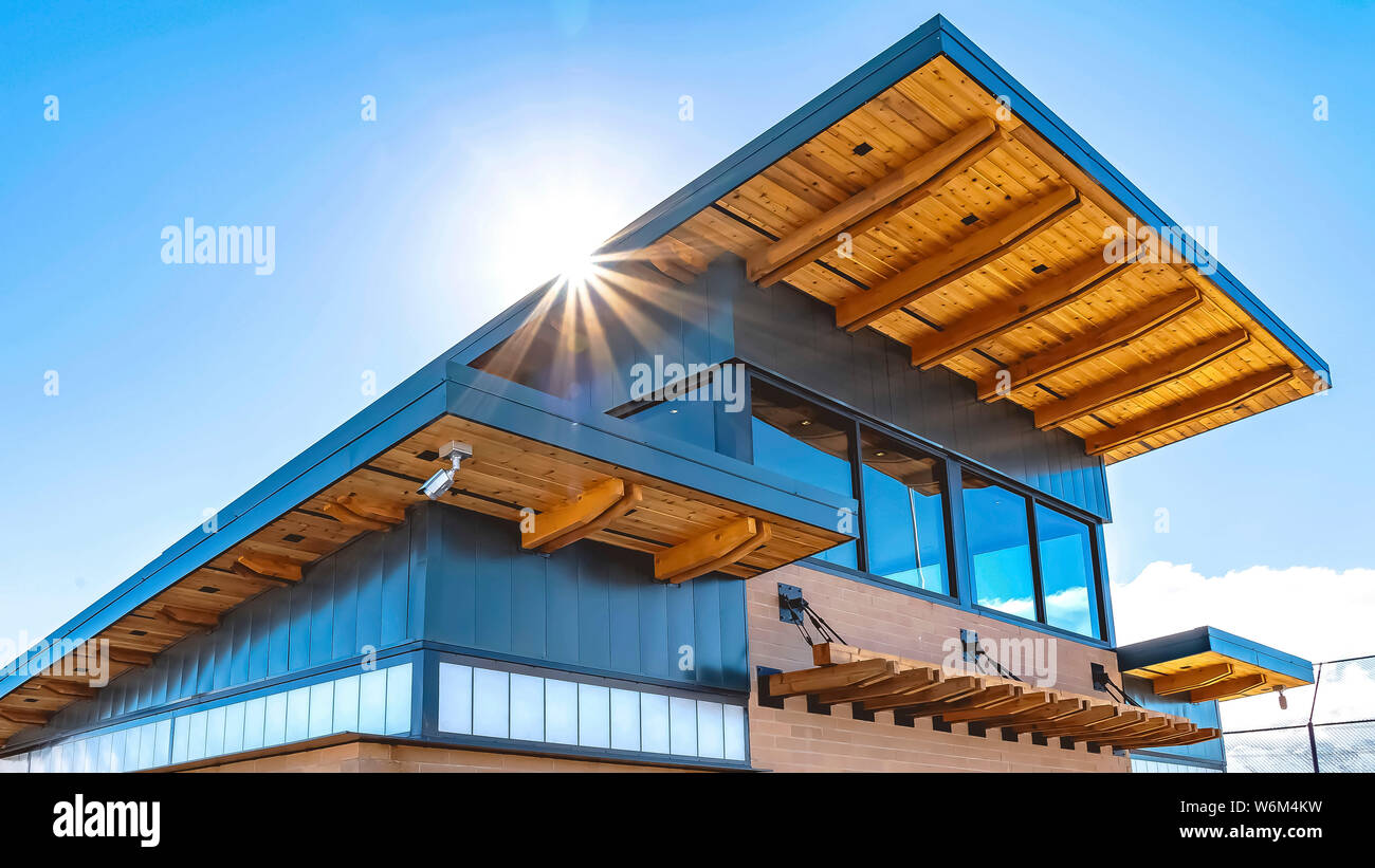 Panorama frame Blue sky and bright sun over a park building with flat ...